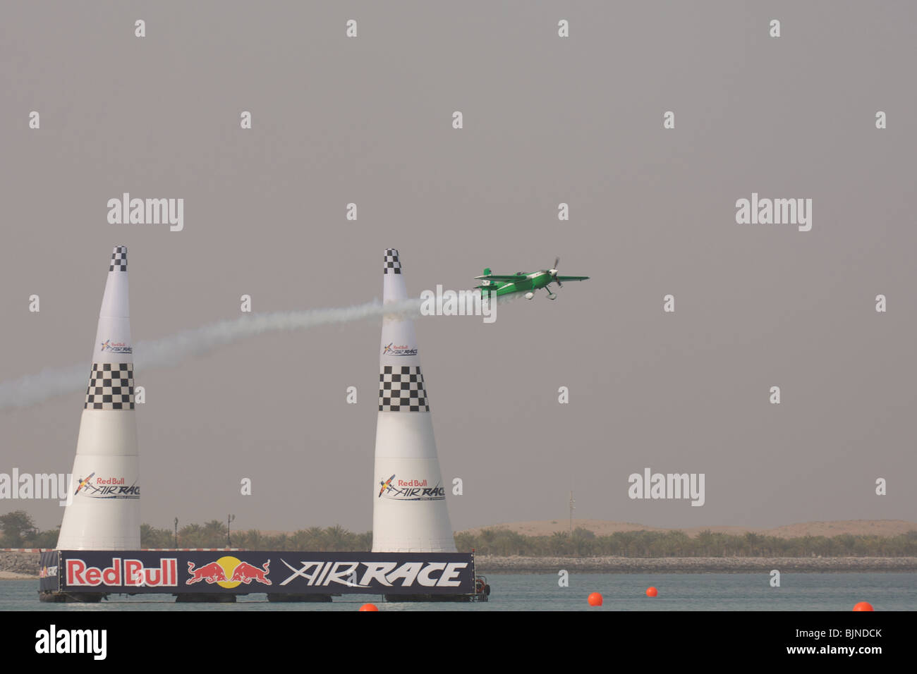 27.03.2010. Abu Dabi. Red Bull Air Race. Plane flies between marker ...