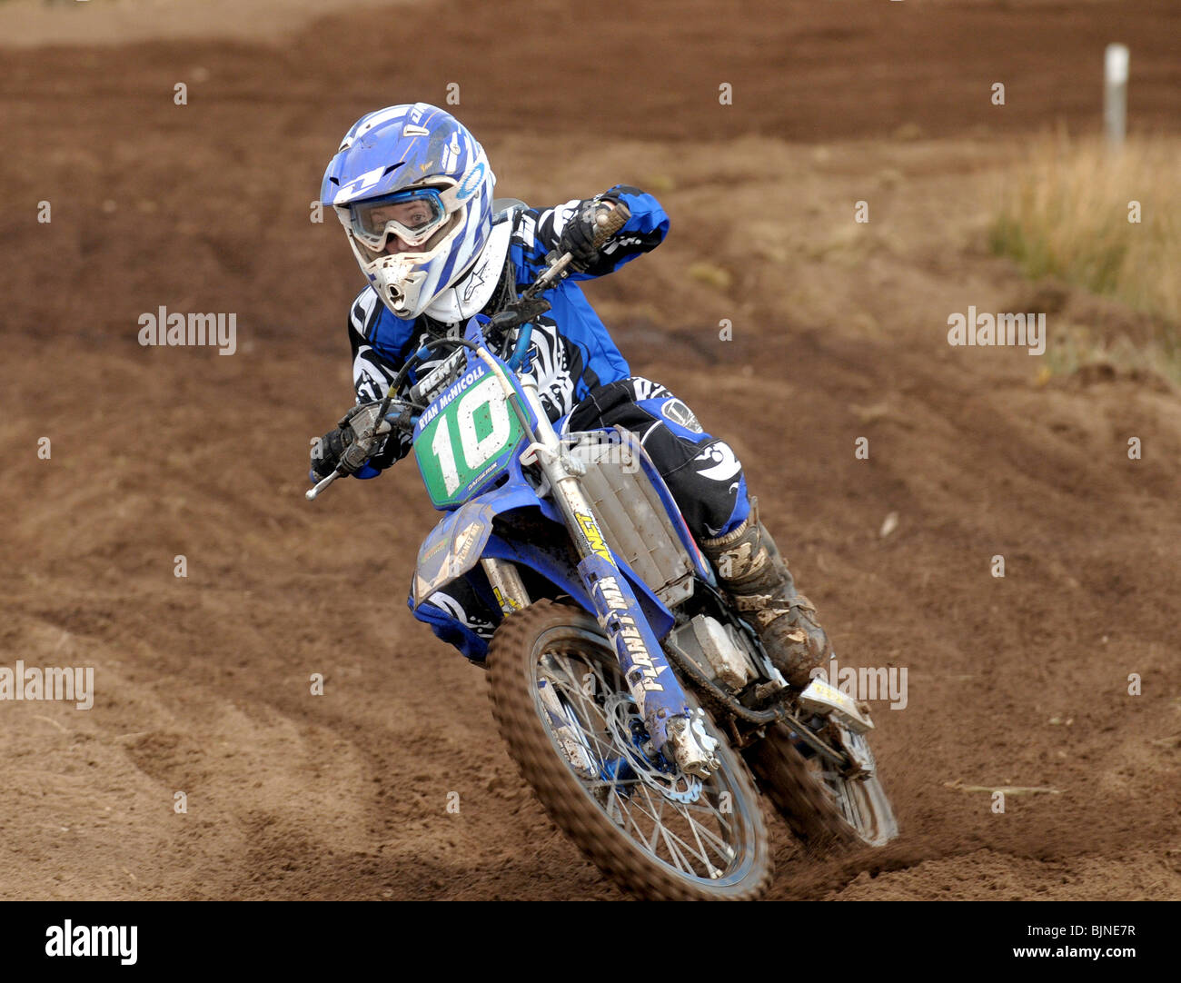 A young boy racer takes a bend on his motorcross bike Stock Photo - Alamy
