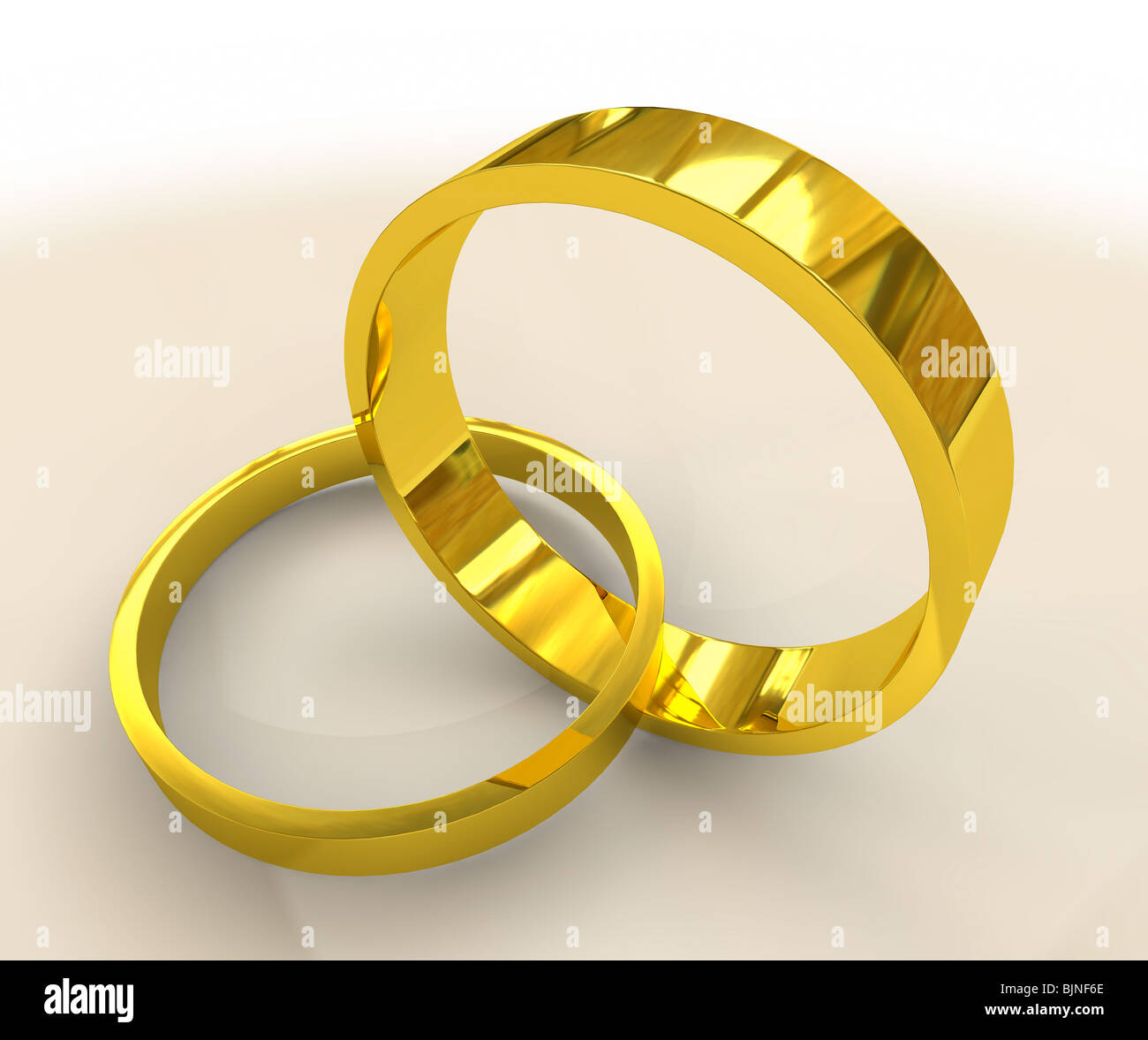 two golden wedding bands linked together as in marriage Stock Photo - Alamy