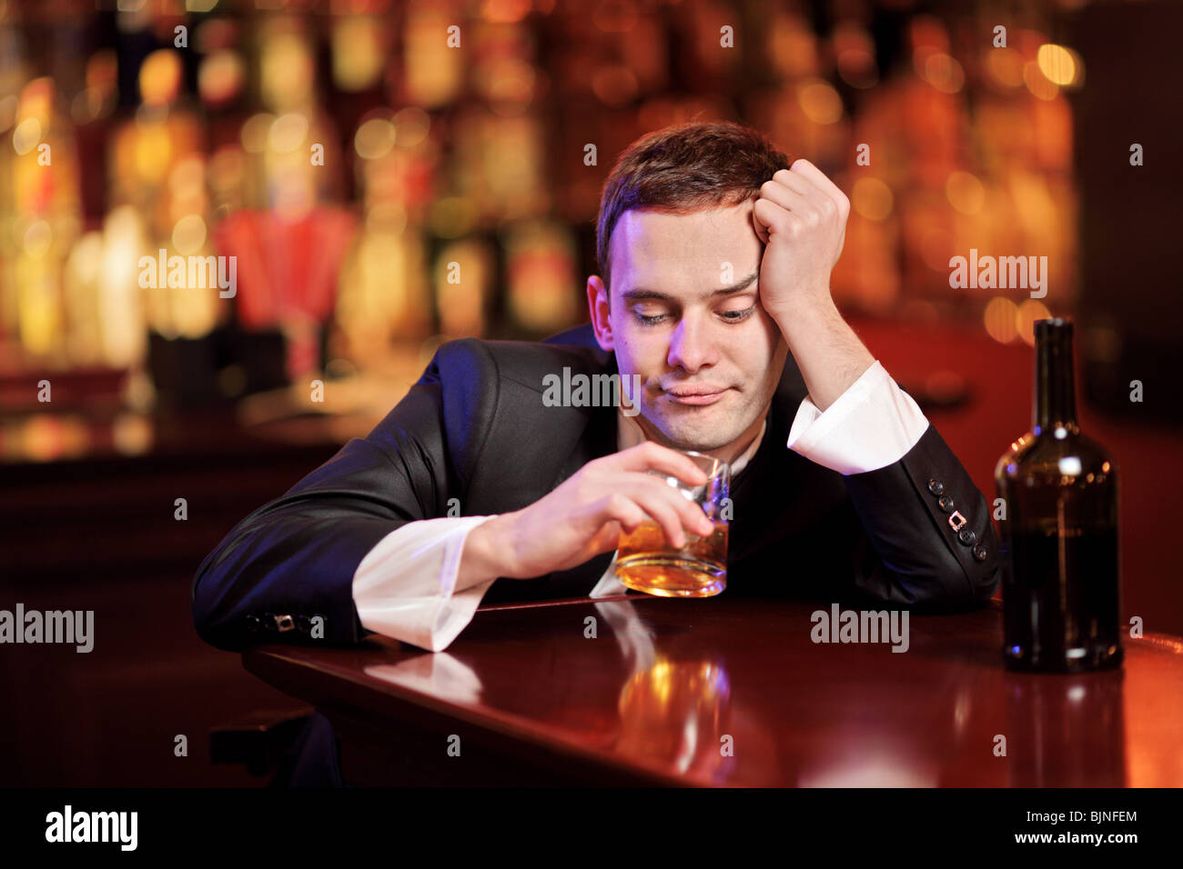 Young drunk man drinking whiskey in the bar Stock Photo - Alamy