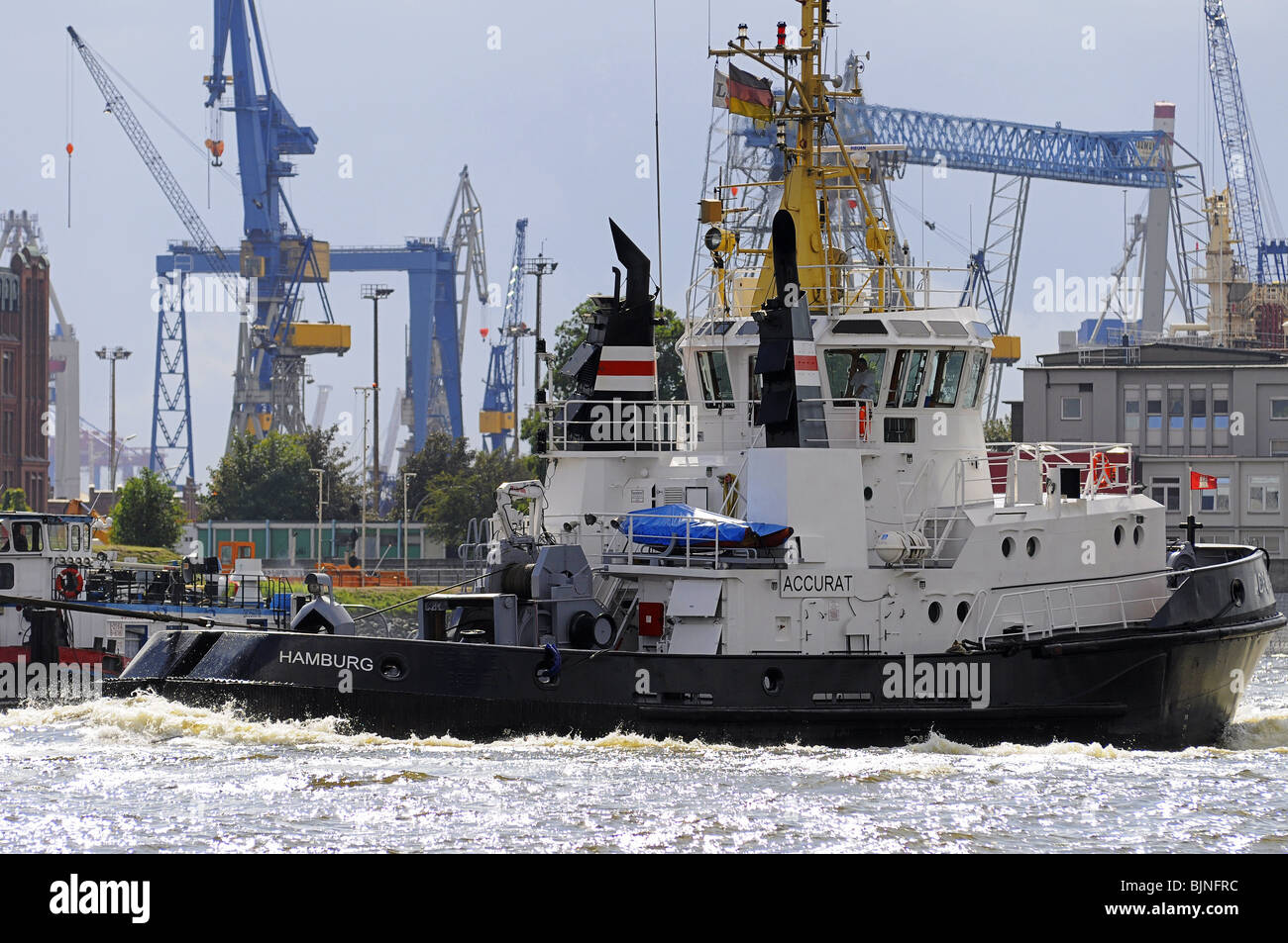 Tug-boat with cranes in Elbe near docks of Hamburg port Stock Photo - Alamy