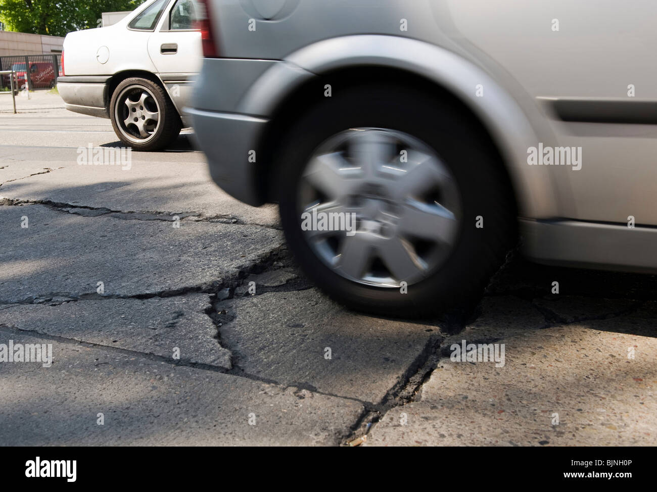 Car driving through a pothole, Berlin, Germany Stock Photo - Alamy