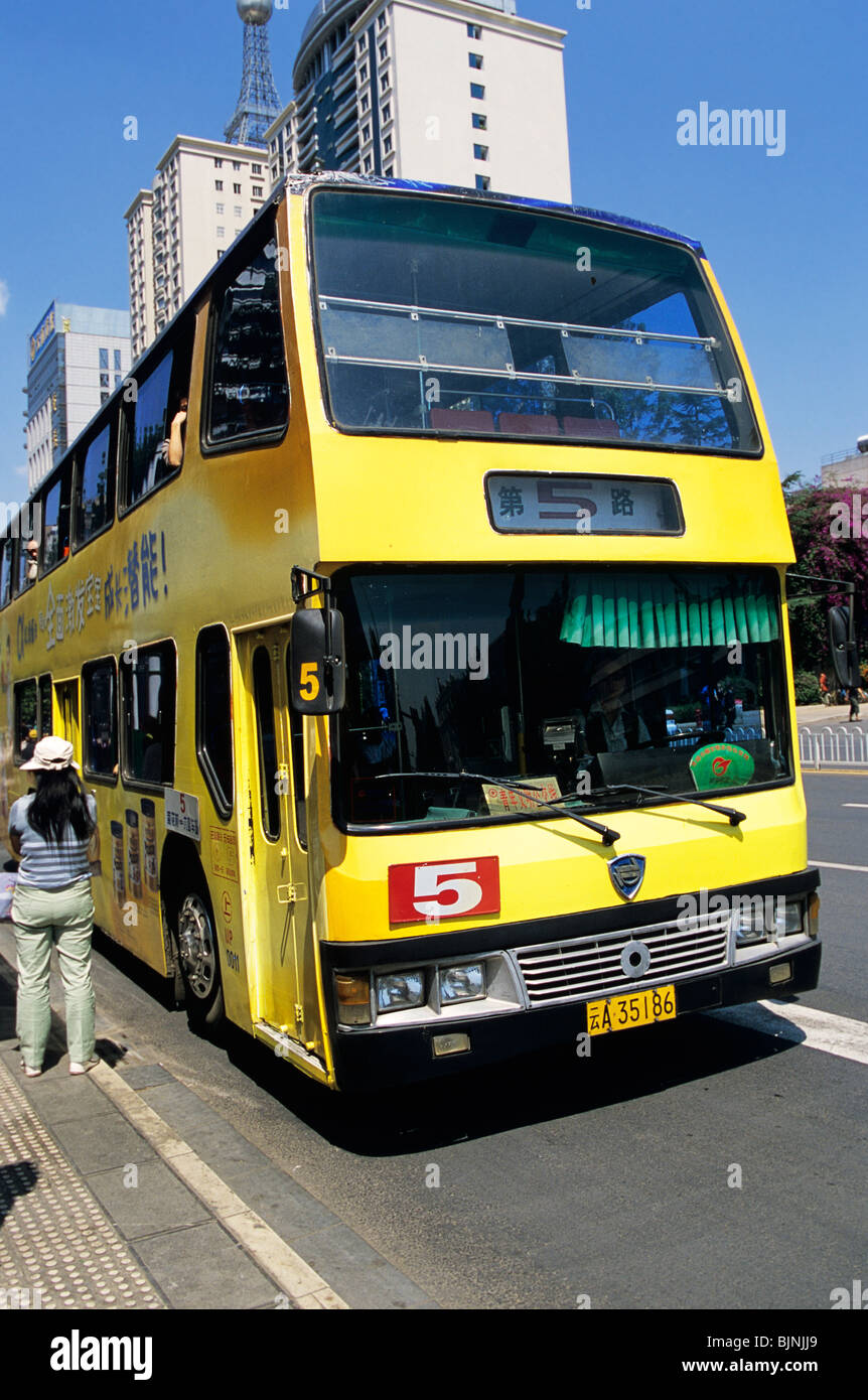 Asia, China, Yunnan Province, Kunming. Double-decker bus is public city ...