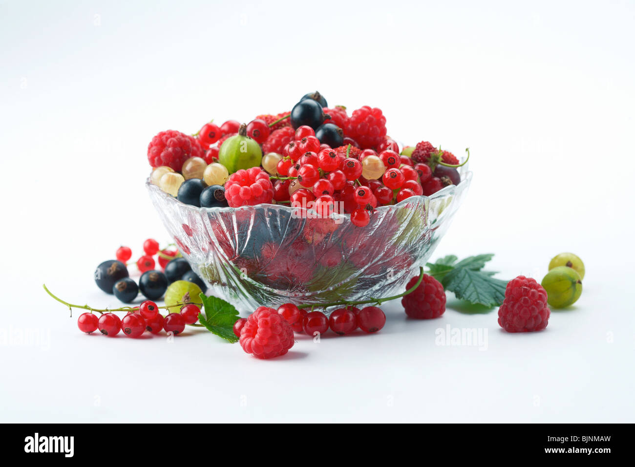 Mixed summer berries in a crystal bowl on white Stock Photo - Alamy