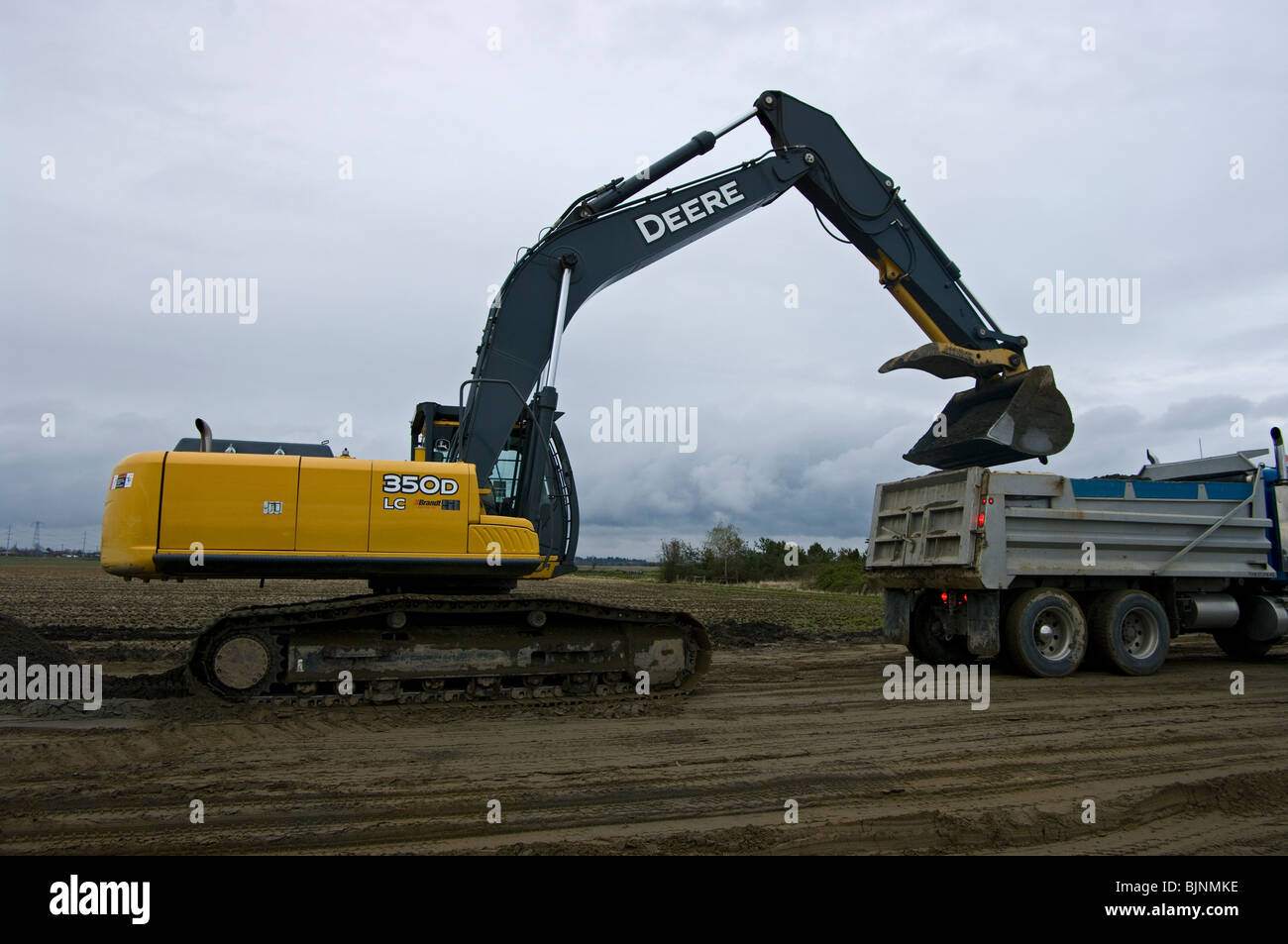 Excavator and Dump Truck Stock Photo - Alamy