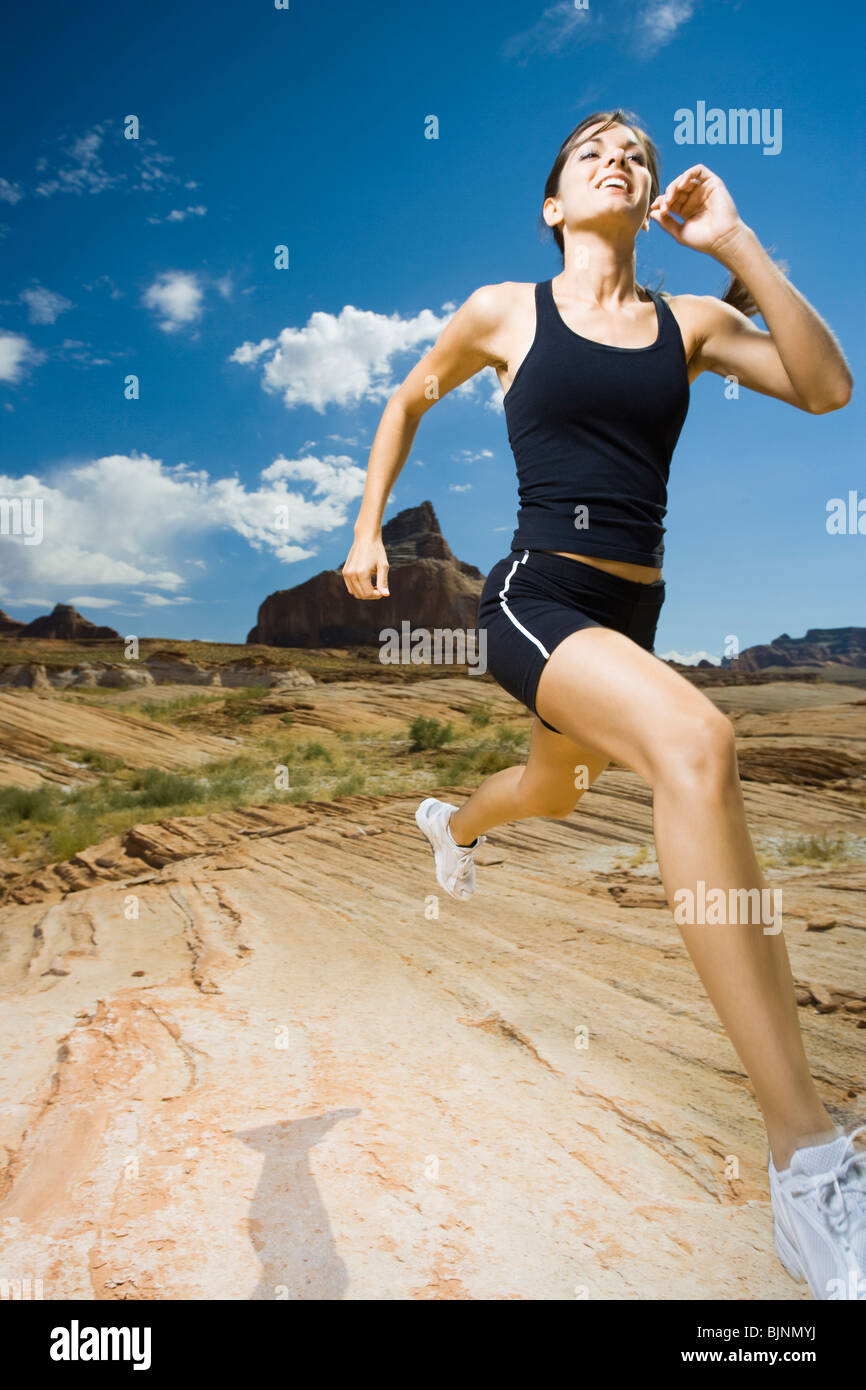 Woman running in desert Stock Photo - Alamy