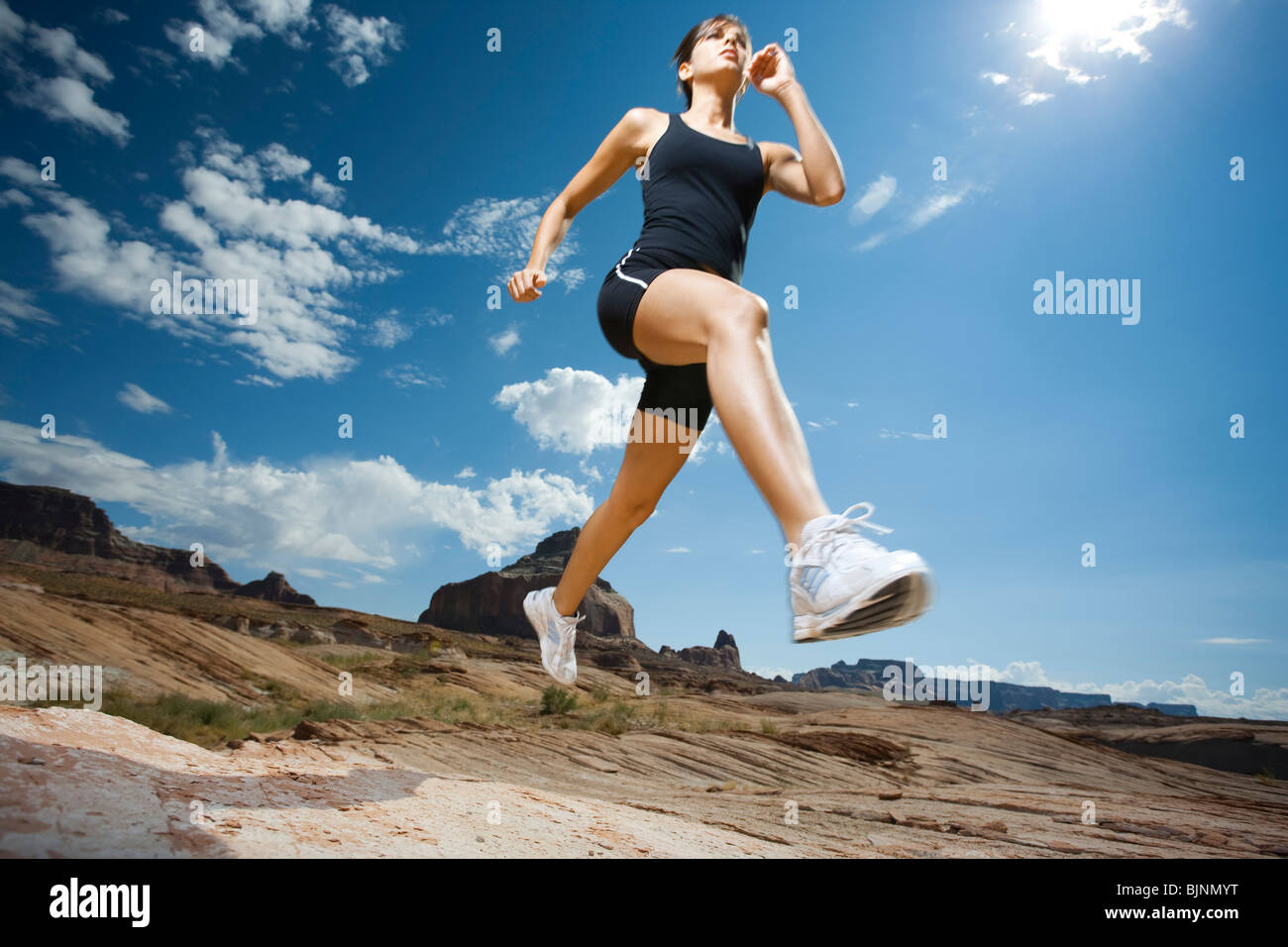 Woman running in desert Stock Photo - Alamy