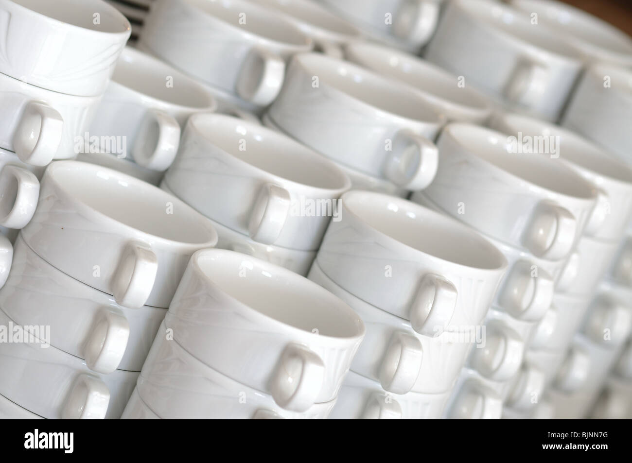 Piles of white ceramic mugs in a restaurant Stock Photo - Alamy