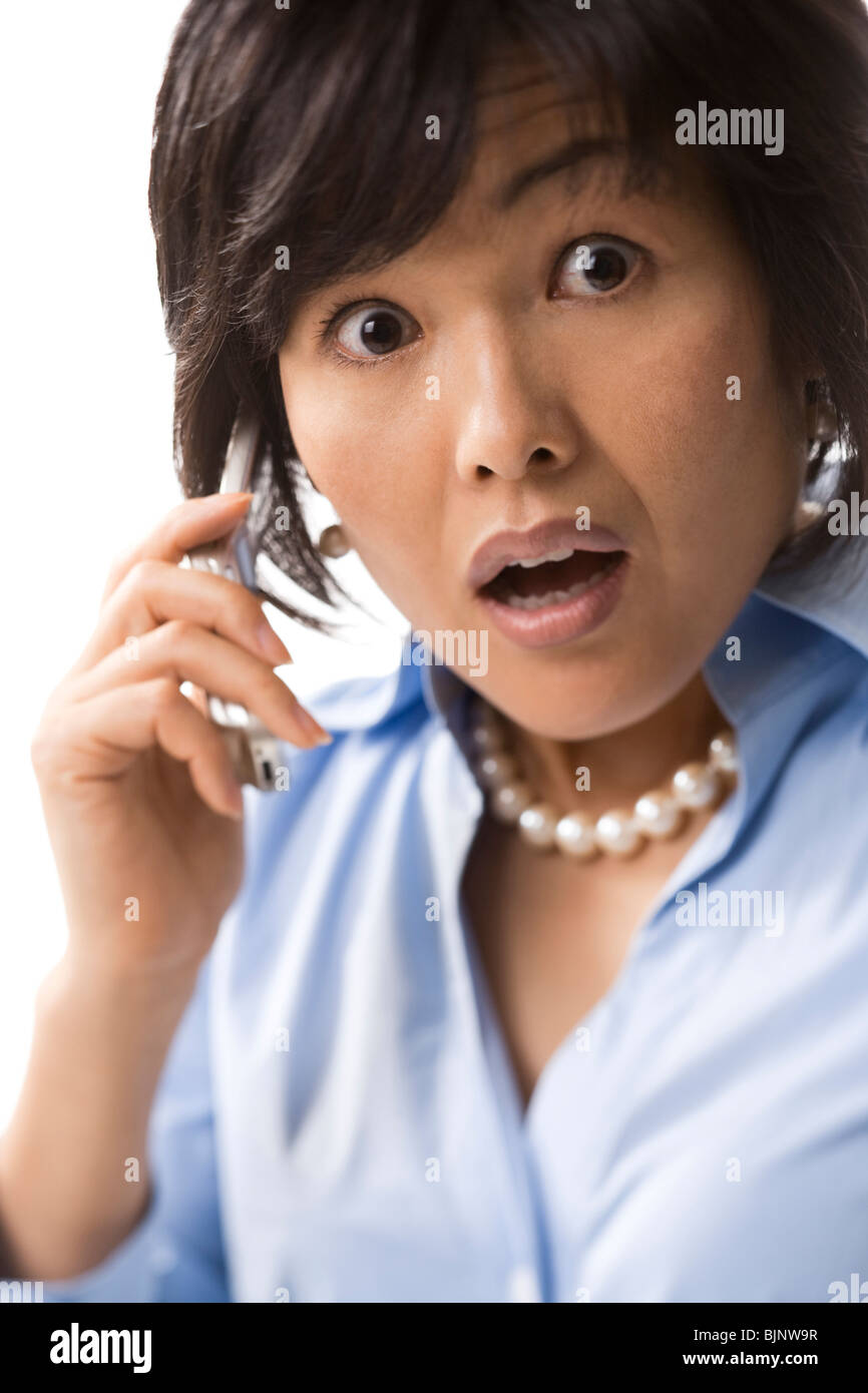 Woman with cell phone laughing Stock Photo - Alamy