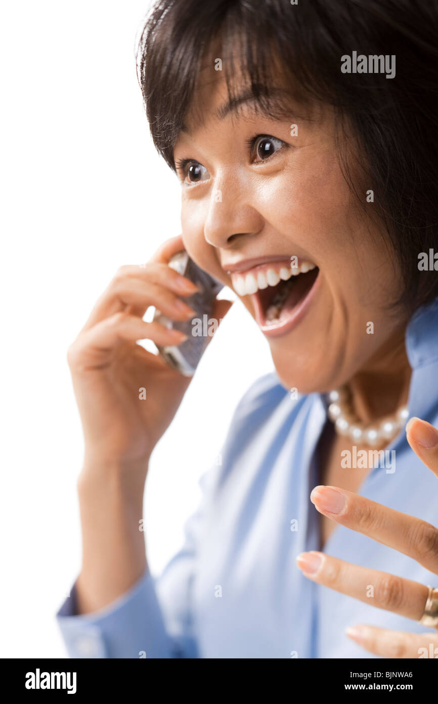 Woman with cell phone laughing Stock Photo - Alamy