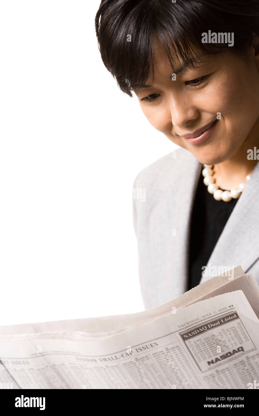 Woman reading newspaper Stock Photo - Alamy