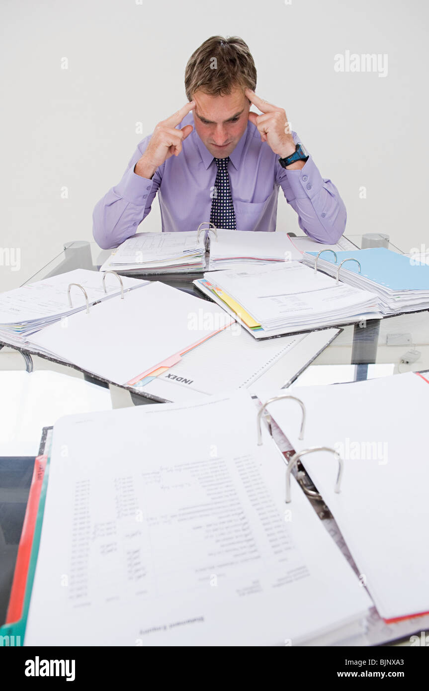 An overworked businessman Stock Photo - Alamy