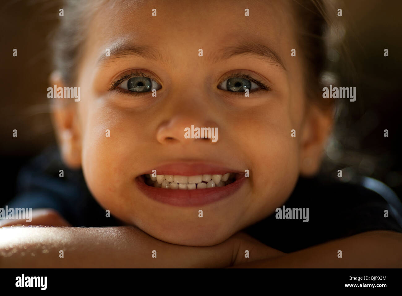 Closeup of girl with chin on hands Stock Photo - Alamy