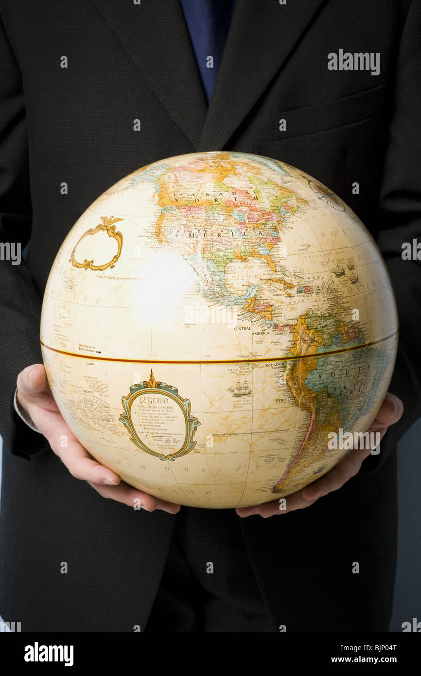 Man holding globe Stock Photo - Alamy