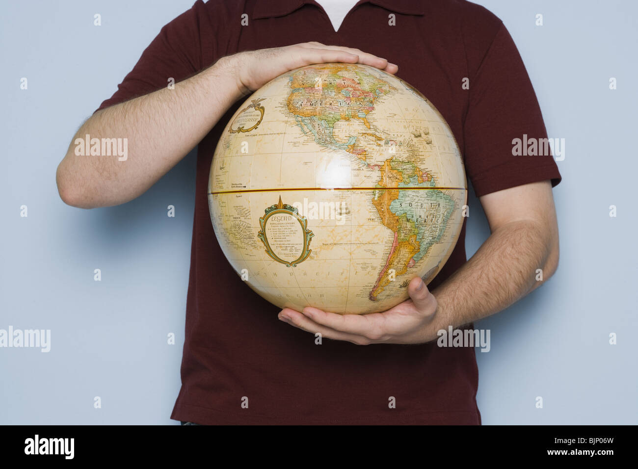 Man holding globe Stock Photo - Alamy