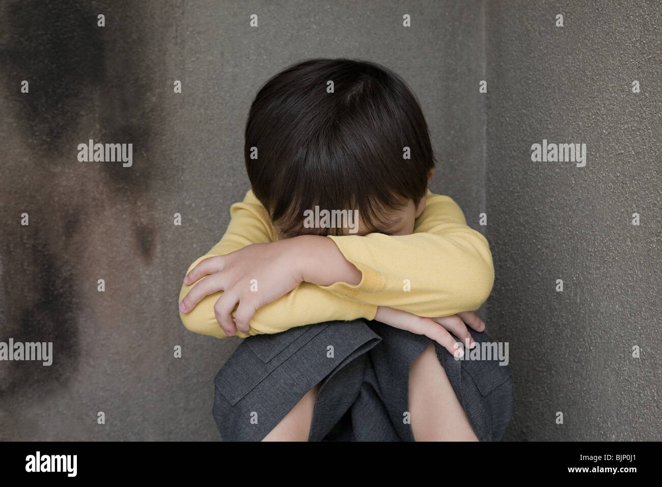Boy crying in a corner Stock Photo - Alamy
