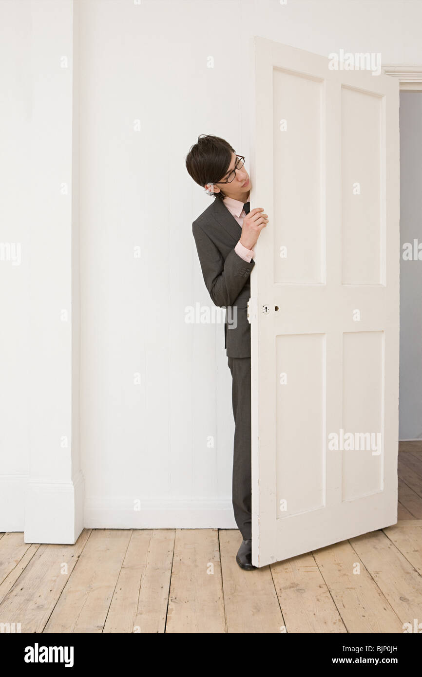 Businessman hiding behind a door Stock Photo - Alamy Businessman hiding behind a door Stock Photo - Alamy