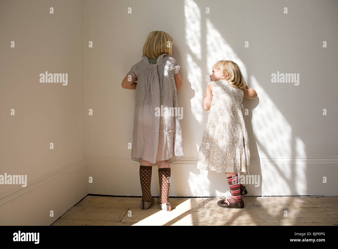 Two girls standing against wall hi-res stock photography and images - Alamy