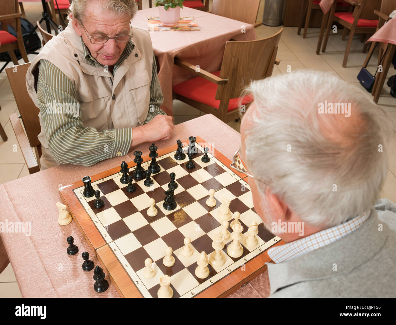 Senior men playing chess Stock Photo - Alamy
