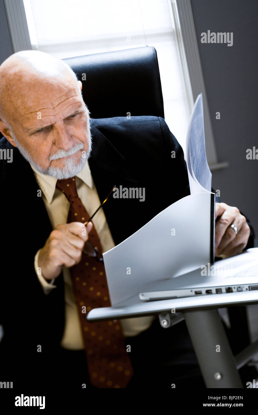 Office worker reading annual reports hi-res stock photography and ...