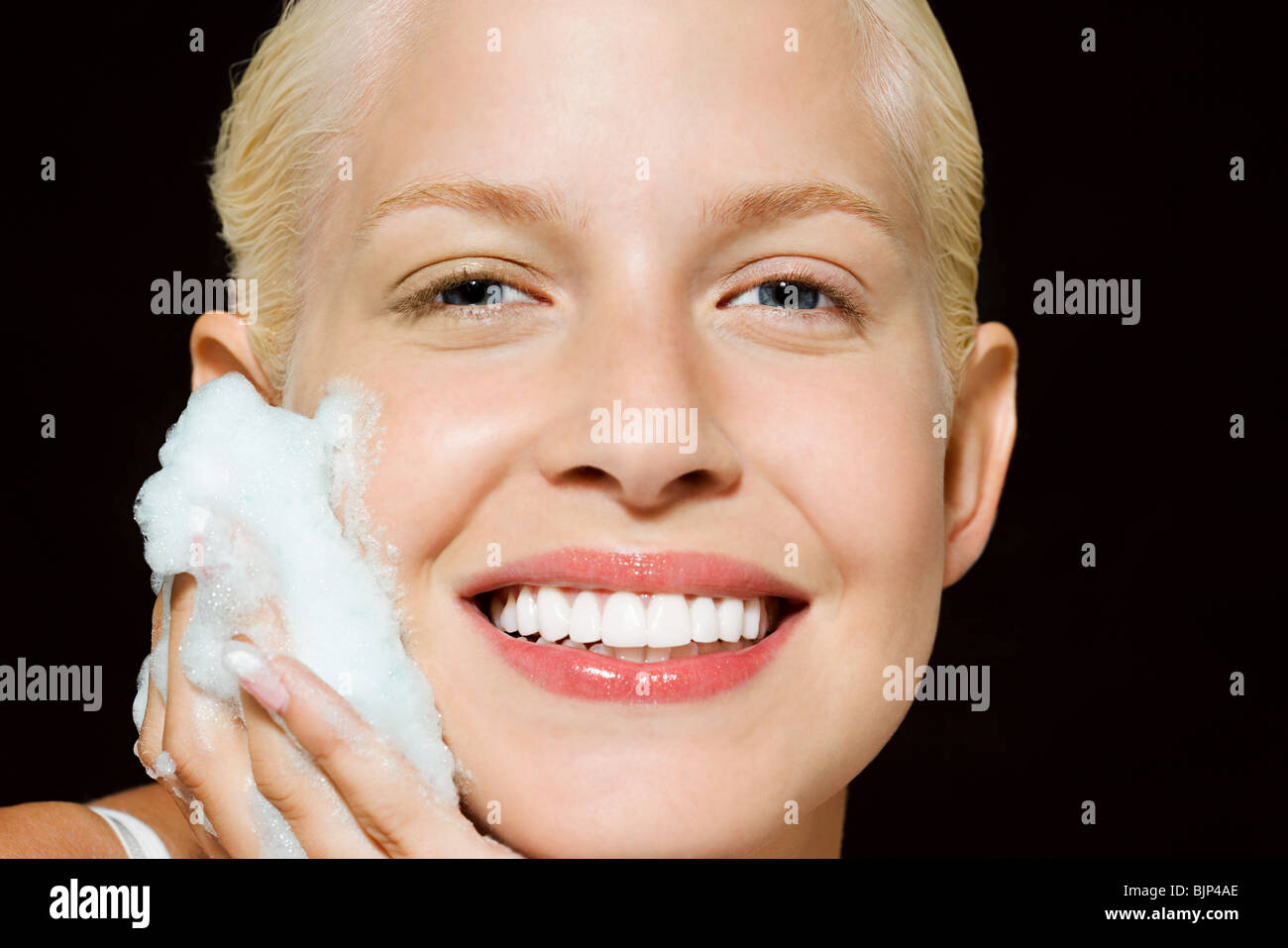 Woman washing her face Stock Photo - Alamy