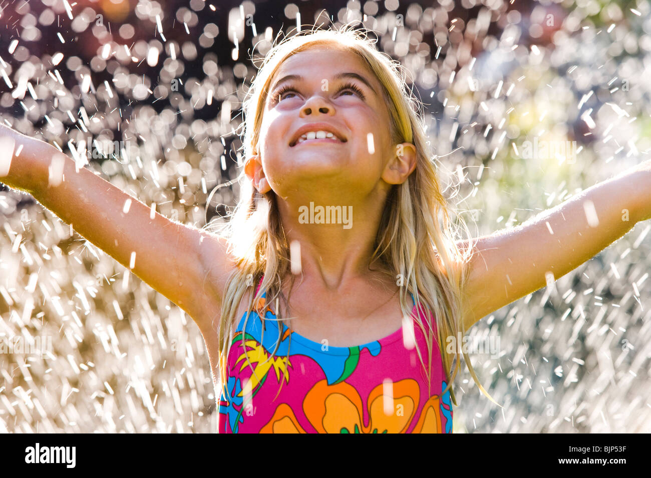 Girl in sprinkler Stock Photo - Alamy