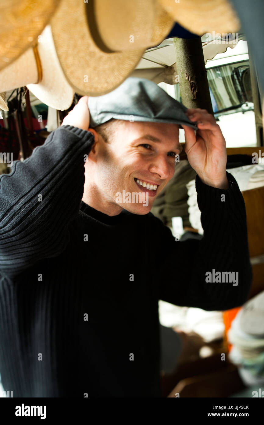 Man adjusting cap Stock Photo - Alamy