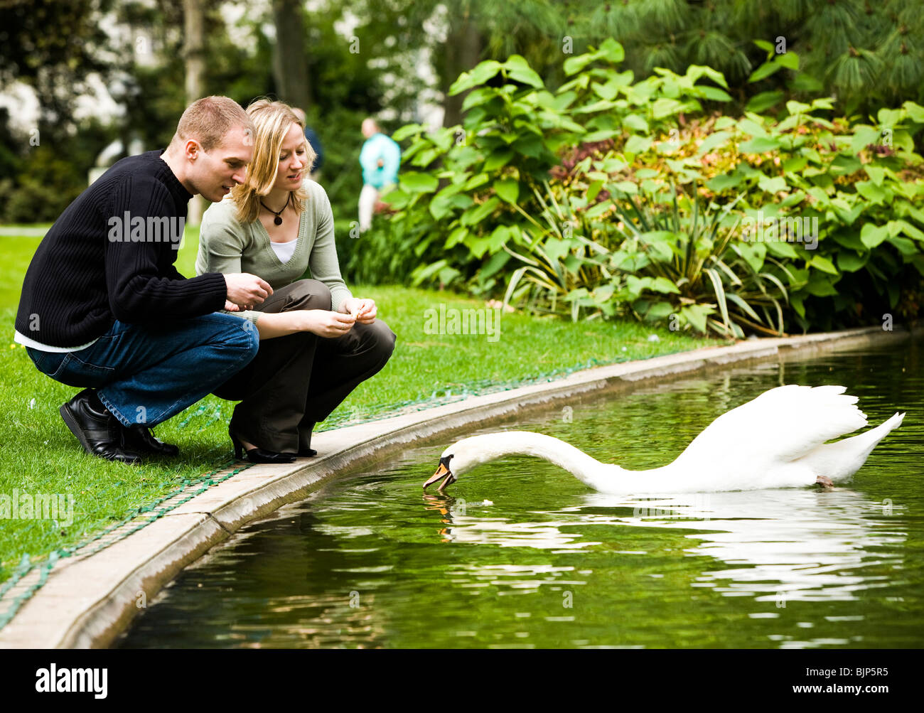 Man and woman and swan Stock Photo - Alamy