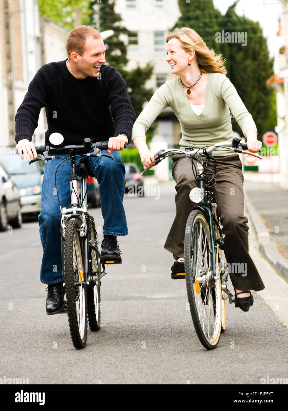 Two people riding bicyles Stock Photo - Alamy