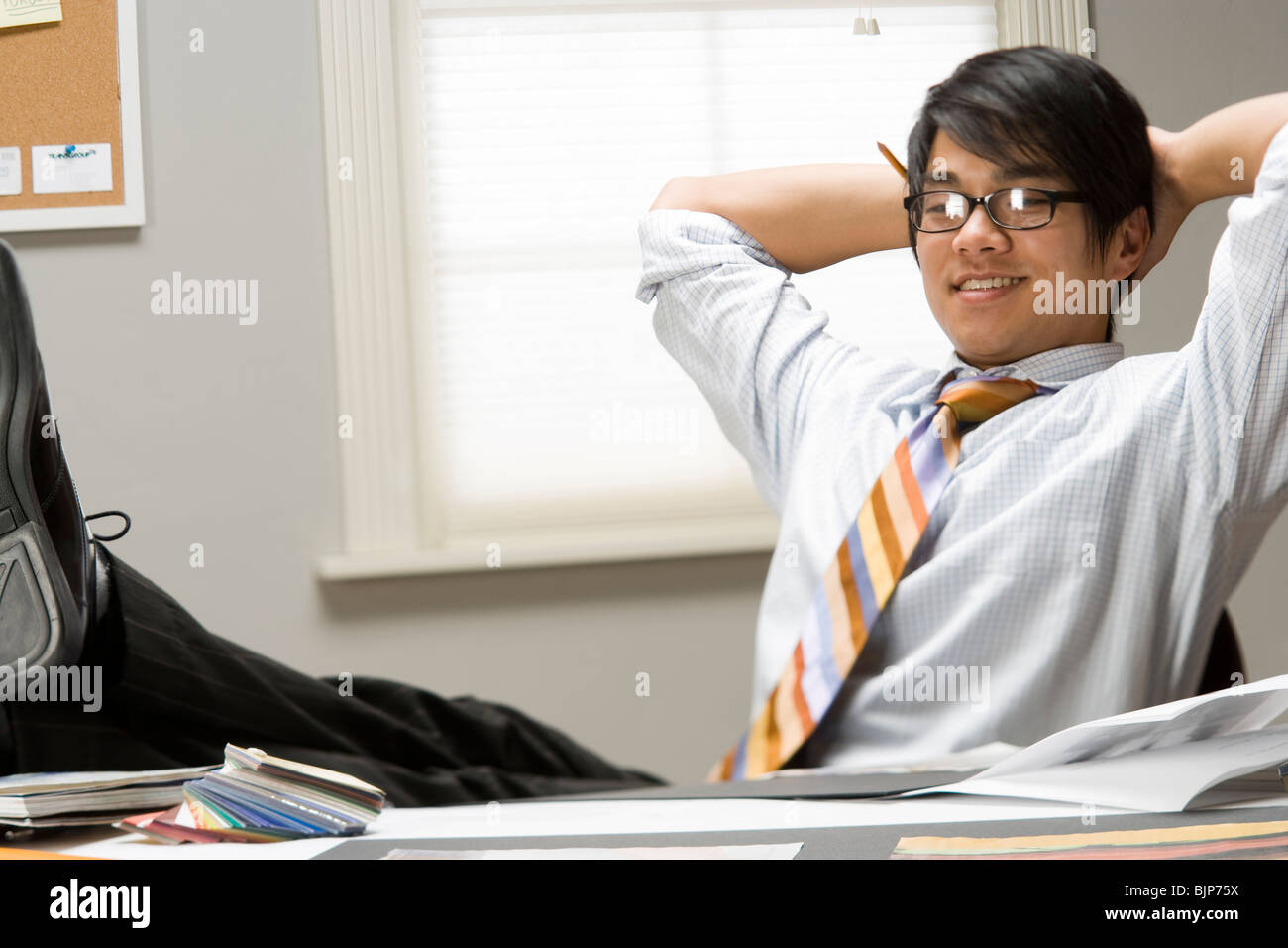 Man in office smiling Stock Photo - Alamy