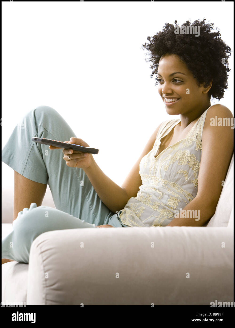 Woman with a remote control Stock Photo - Alamy