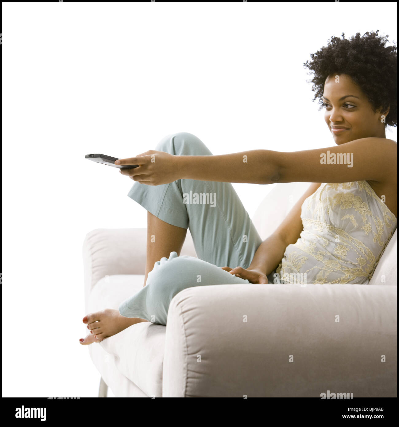 Woman with a remote control Stock Photo - Alamy