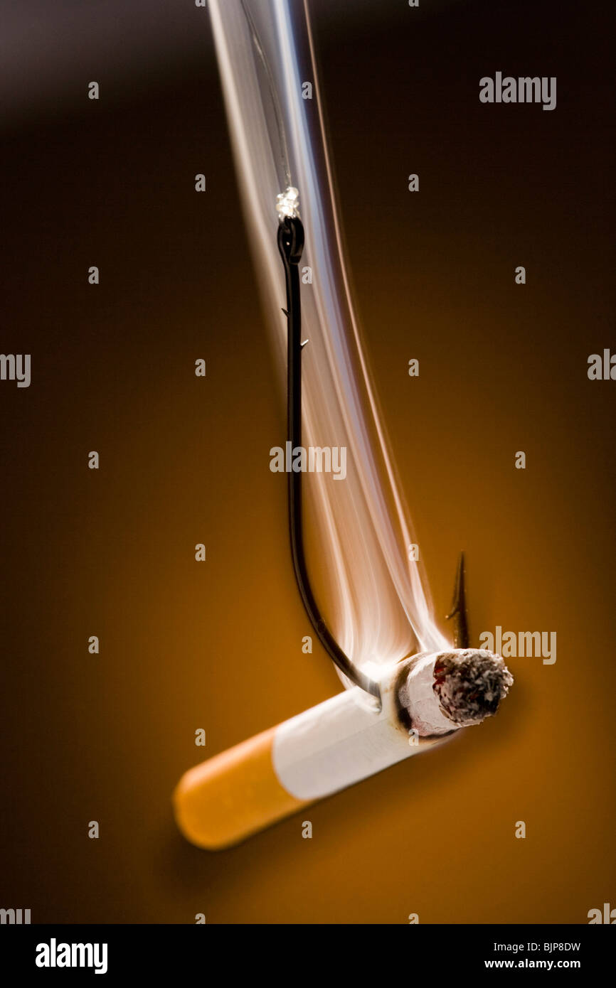 Cigarette with a fish hook through it Stock Photo - Alamy