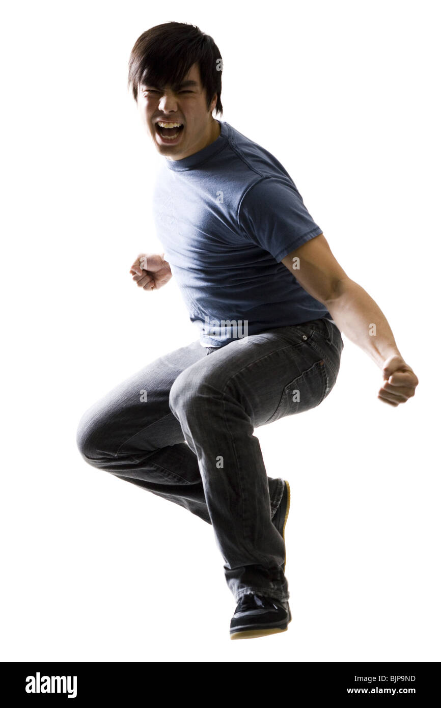 Young adult men jumping Stock Photo - Alamy