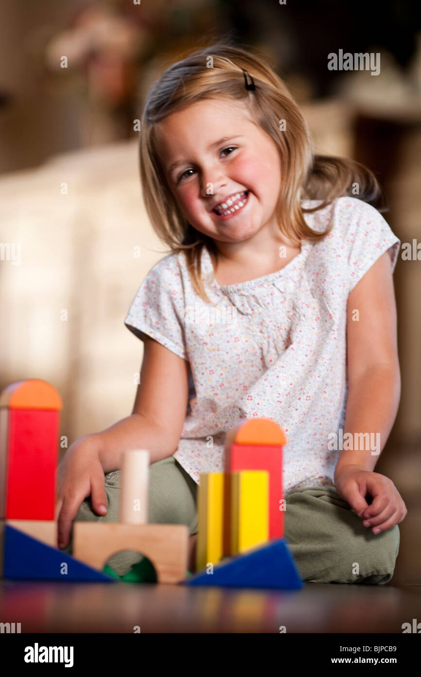 Girl playing with blocks Stock Photo - Alamy