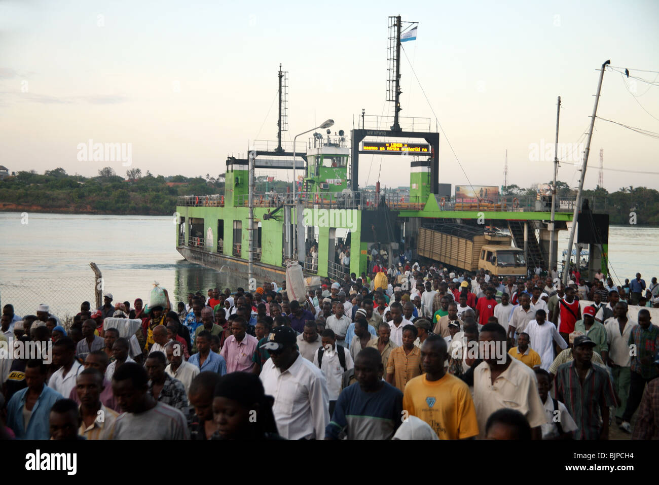 Vehicles and passengers disembarking from The MV Kilindini Ferry at ...