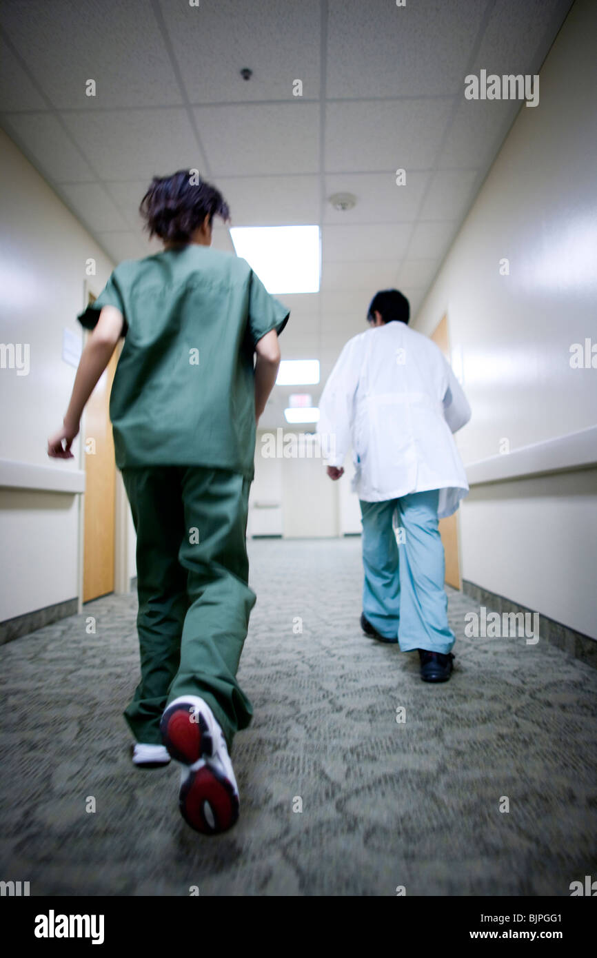 Doctor running hospital behind hi-res stock photography and images - Alamy