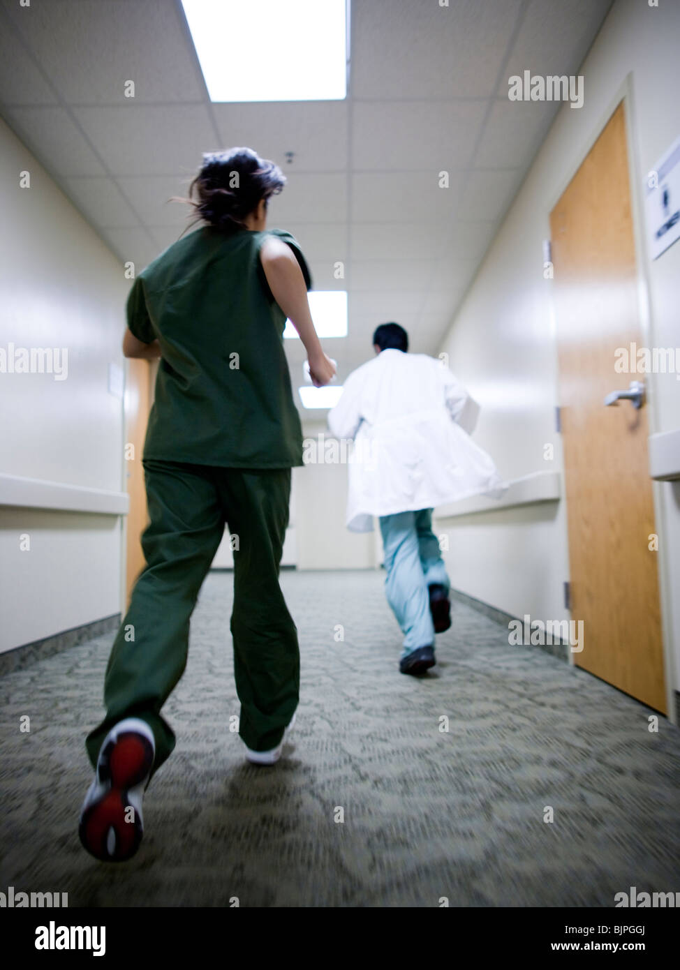 Doctor running hospital behind hi-res stock photography and images - Alamy