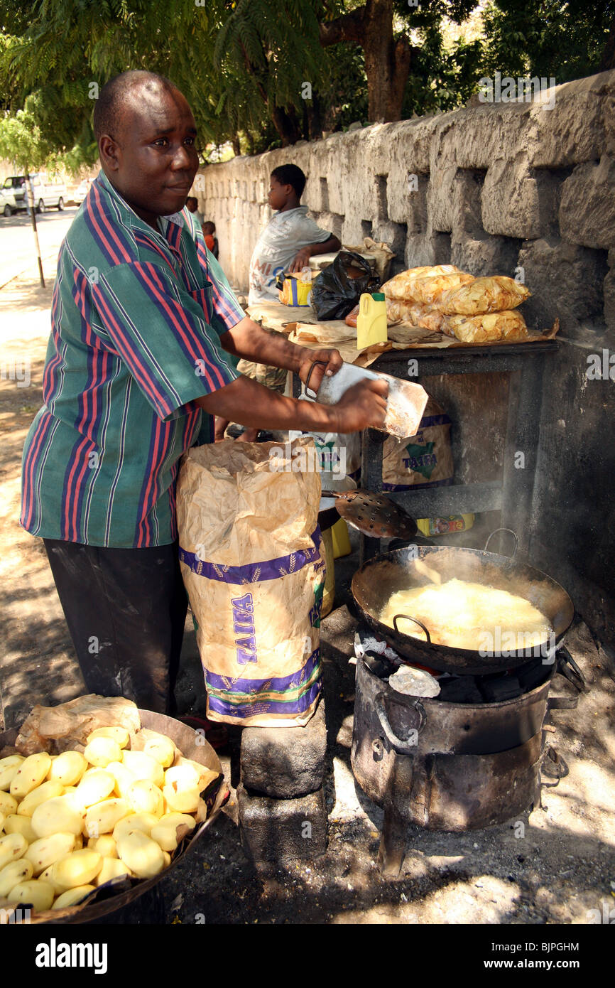 Man cooking cassava chips near Jesus fort Mombasa Stock Photo - Alamy