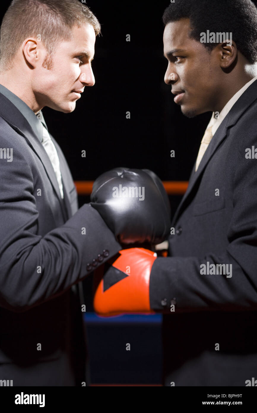 Side profile of two businessmen fighting hi-res stock photography and ...