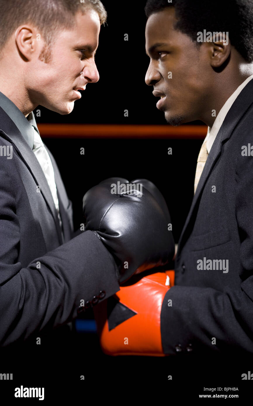 Side profile of two businessmen fighting hi-res stock photography and ...