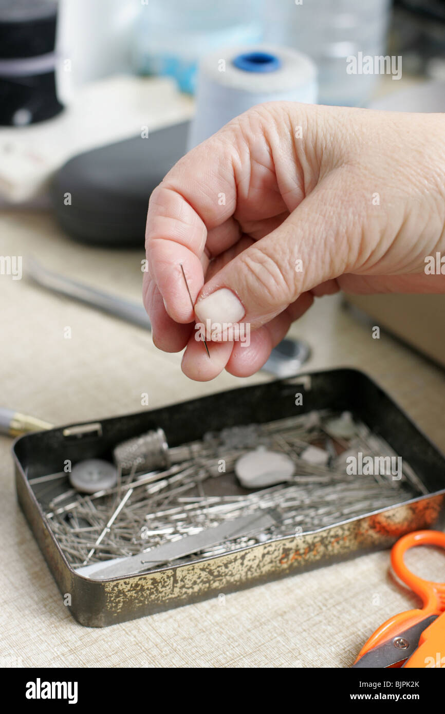 Close up of woman`s hand with a threading needle Stock Photo - Alamy