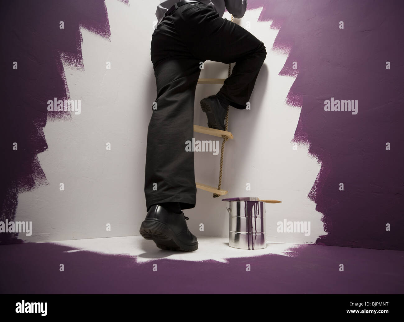 Man climbing a ladder Stock Photo - Alamy