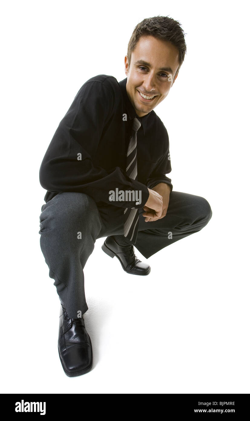 High angle view portrait of young man crouching hi-res stock ...
