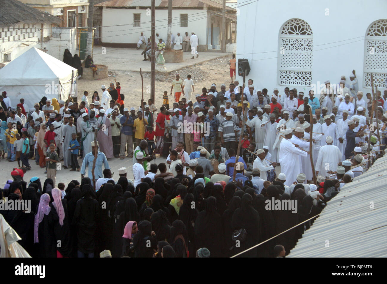 Swahili men and women celebrating Maulidi outside Riyadha Mosque Lamu ...