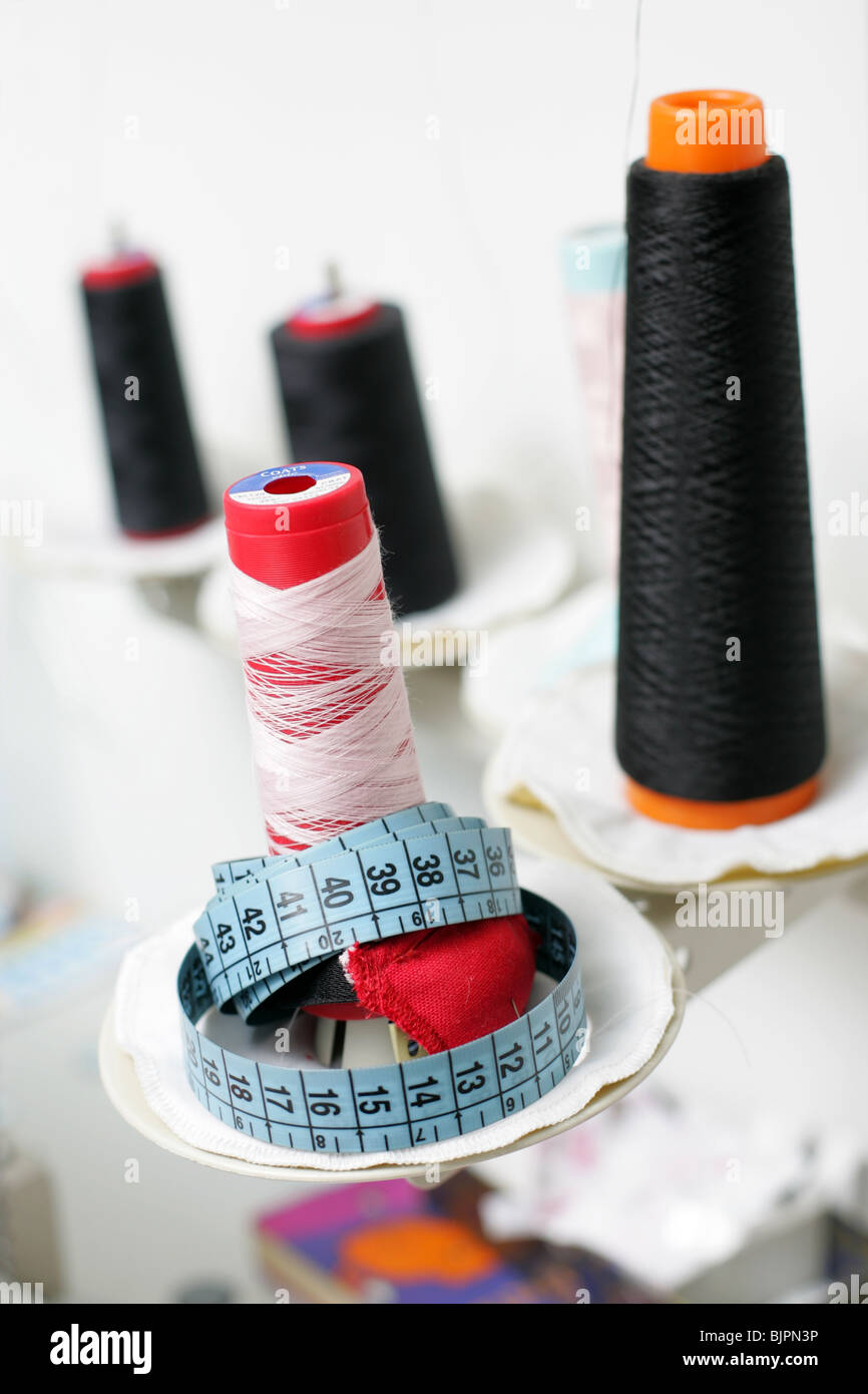 Sewing thread and measuring tape on a sewing machine Stock Photo - Alamy