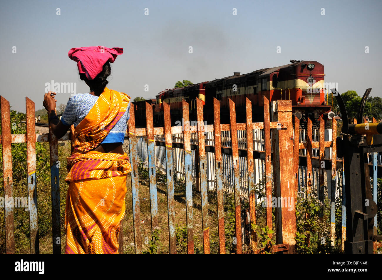Woman watching a train go by Stock Photo - Alamy