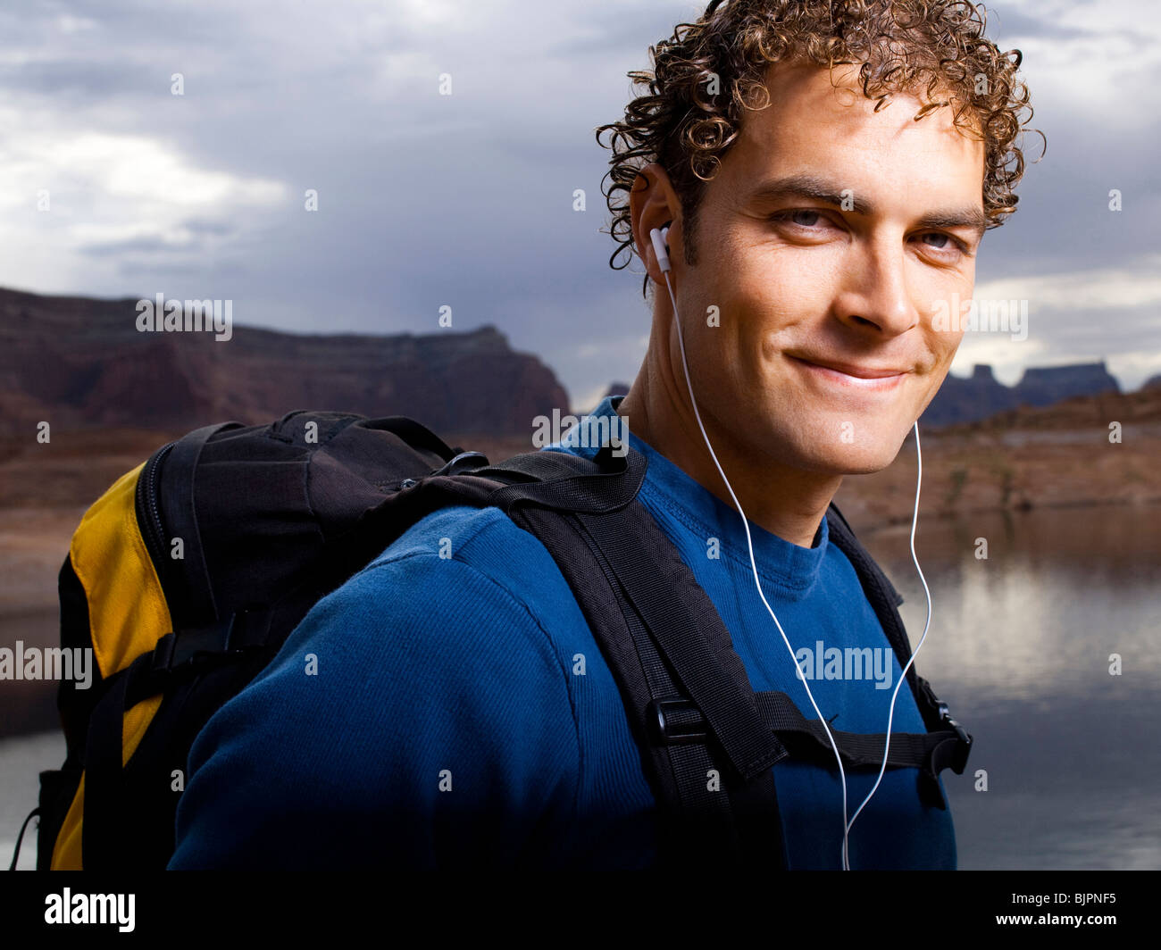 Man with backpack and scenic background Stock Photo - Alamy