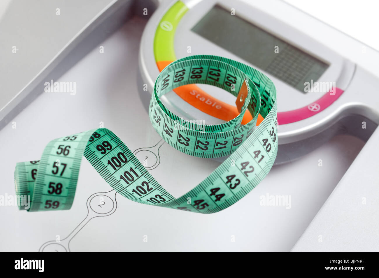 scale and measuring tape on white background Stock Photo - Alamy