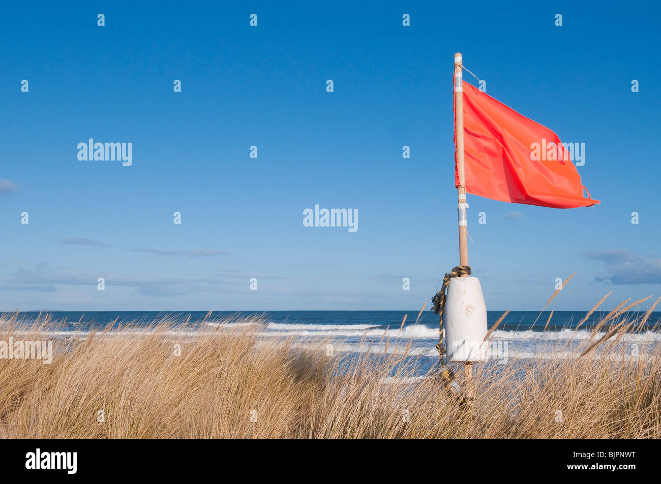 Flag flying over a beach hi-res stock photography and images - Alamy